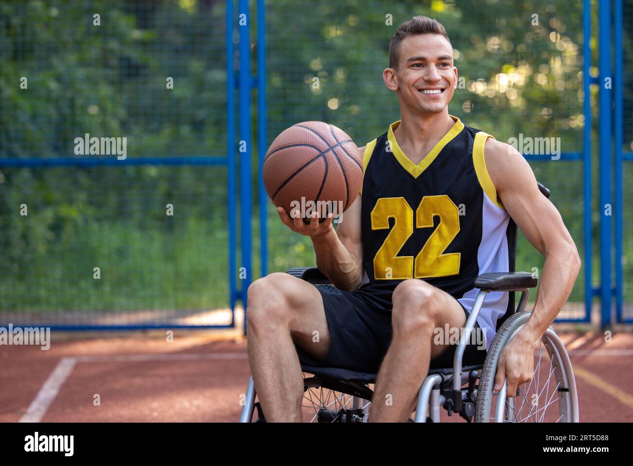Wheelchair basketball player holding, disability, outdoor basketball ...
