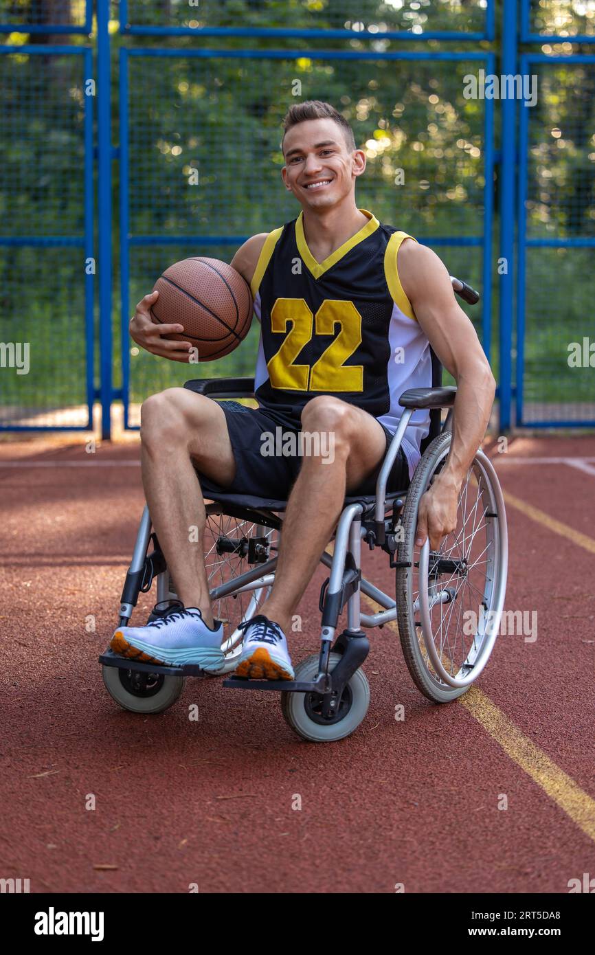 Wheelchair basketball player holding, disability, outdoor basketball ...