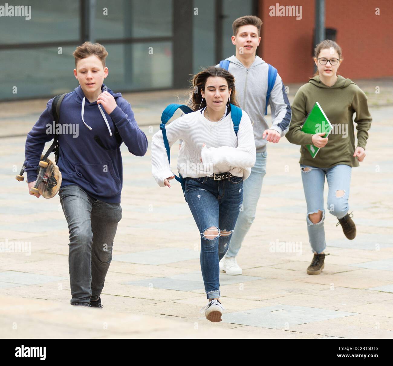 Teenager school kids running Stock Photo - Alamy