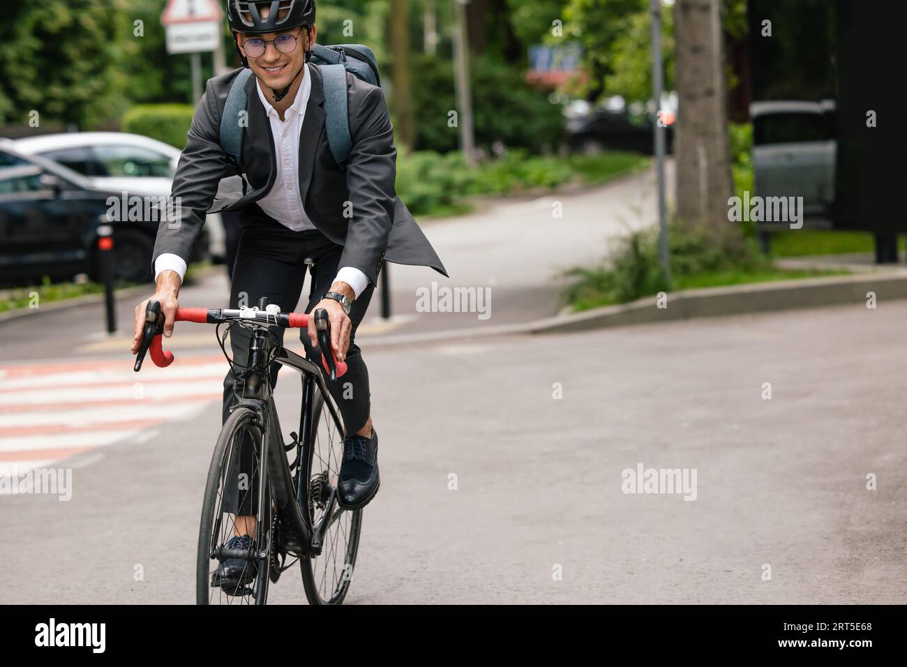Manager commuting to the office by bike Stock Photo - Alamy
