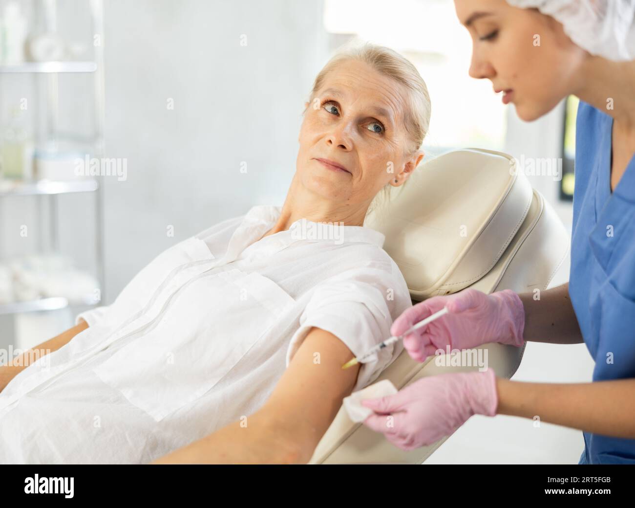 Healthcare professional administering injection patient hi-res stock ...