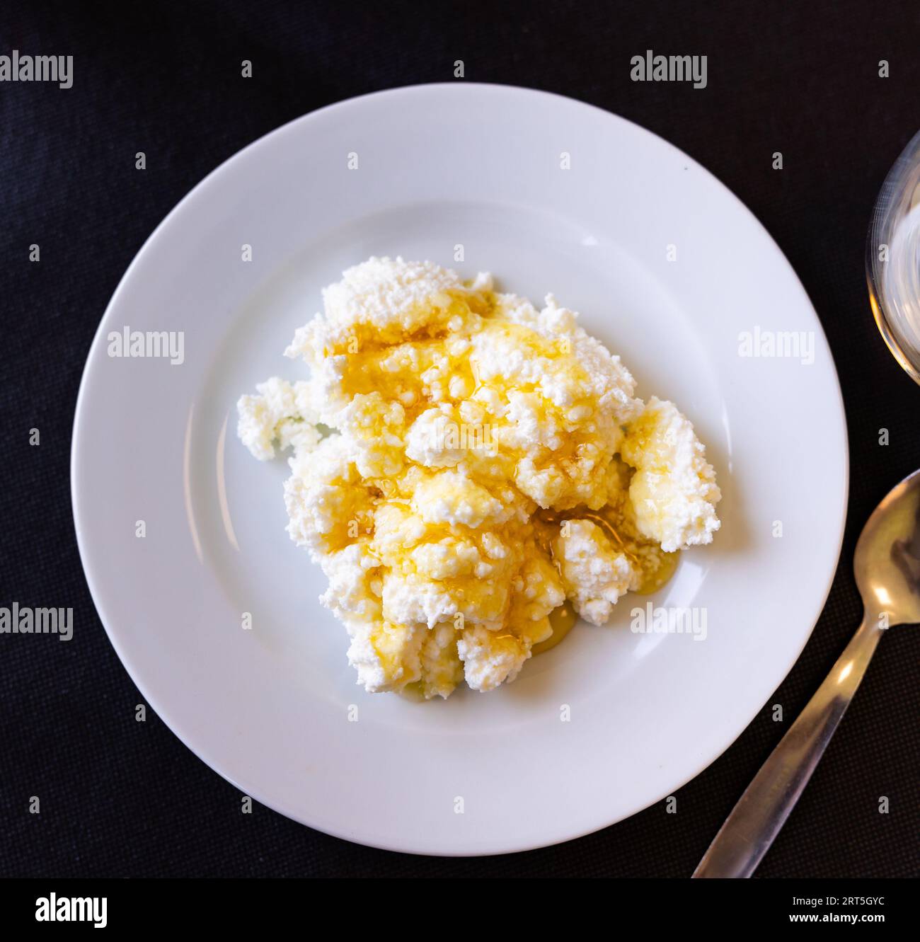 Fresh mato cheese from goat milk served with honey Stock Photo - Alamy