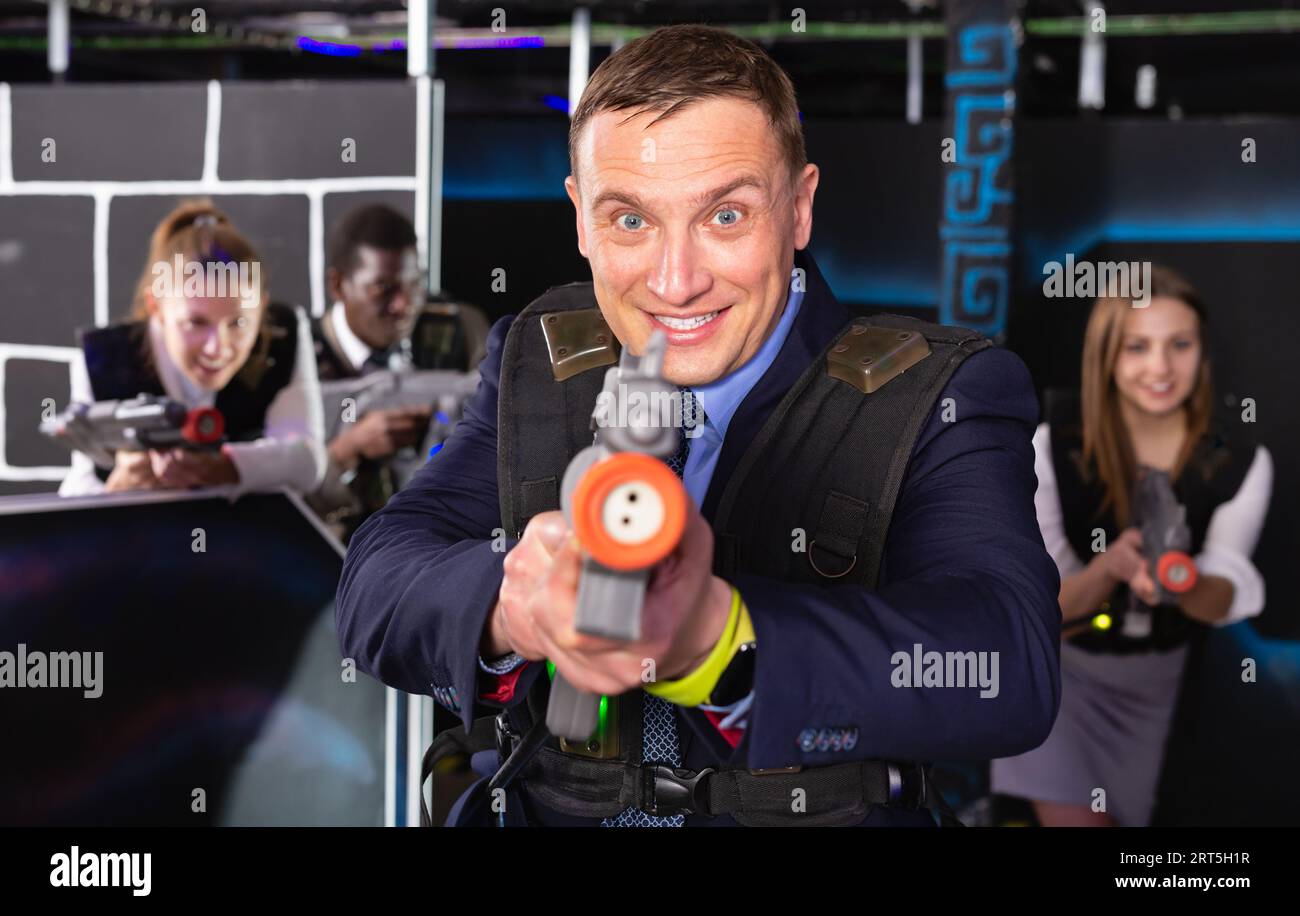 Man holding laser gun and playing laser tag Stock Photo - Alamy