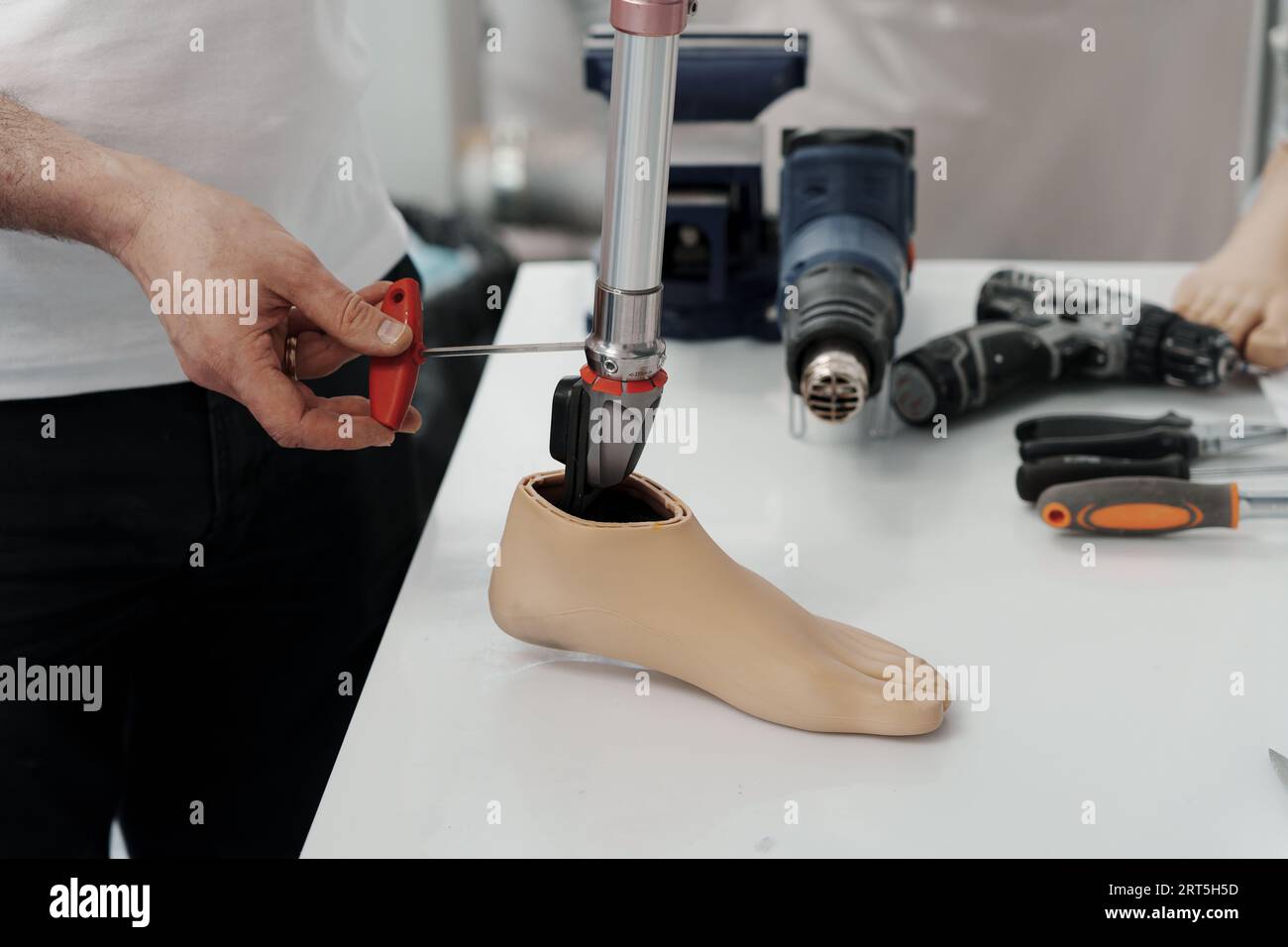 Master screwing and tightening metal part of modern prosthetic leg ...