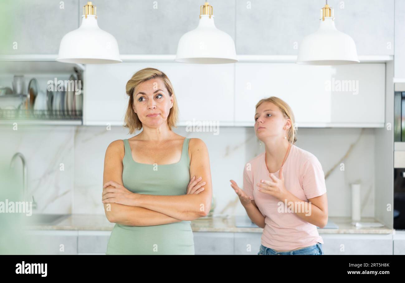Teenage daughter asking mother to forgive after argument Stock Photo ...