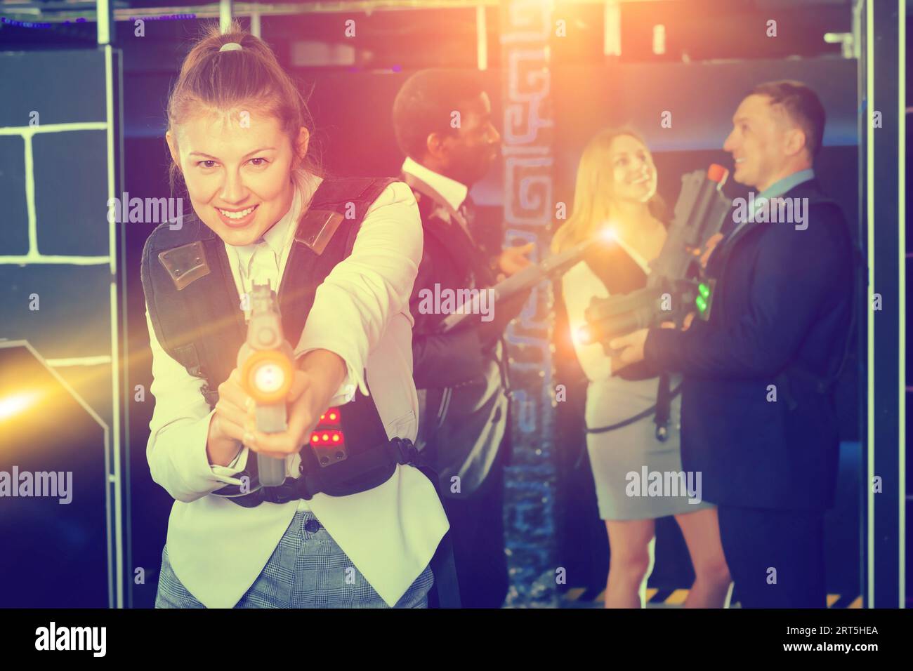 Woman holding laser gun and playing laser tag Stock Photo - Alamy