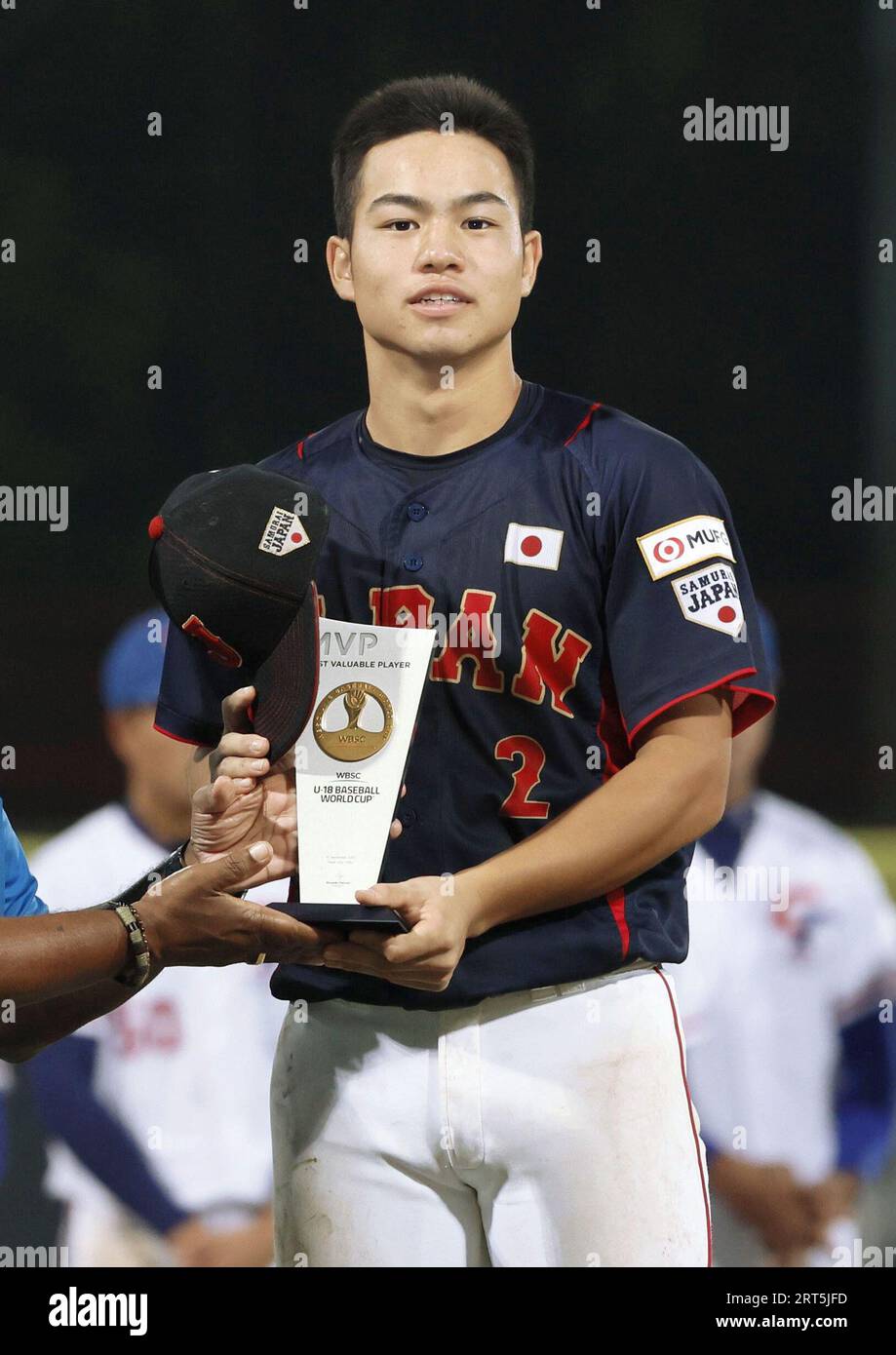 Yokohama High School infielder Ren Ogata receives his MVP trophy after ...