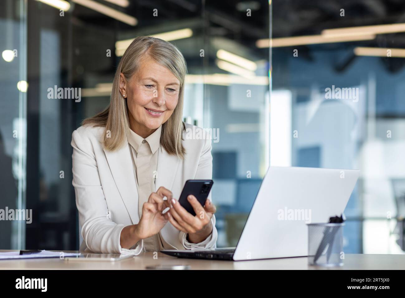 Senior mature experienced woman at workplace inside office, business ...