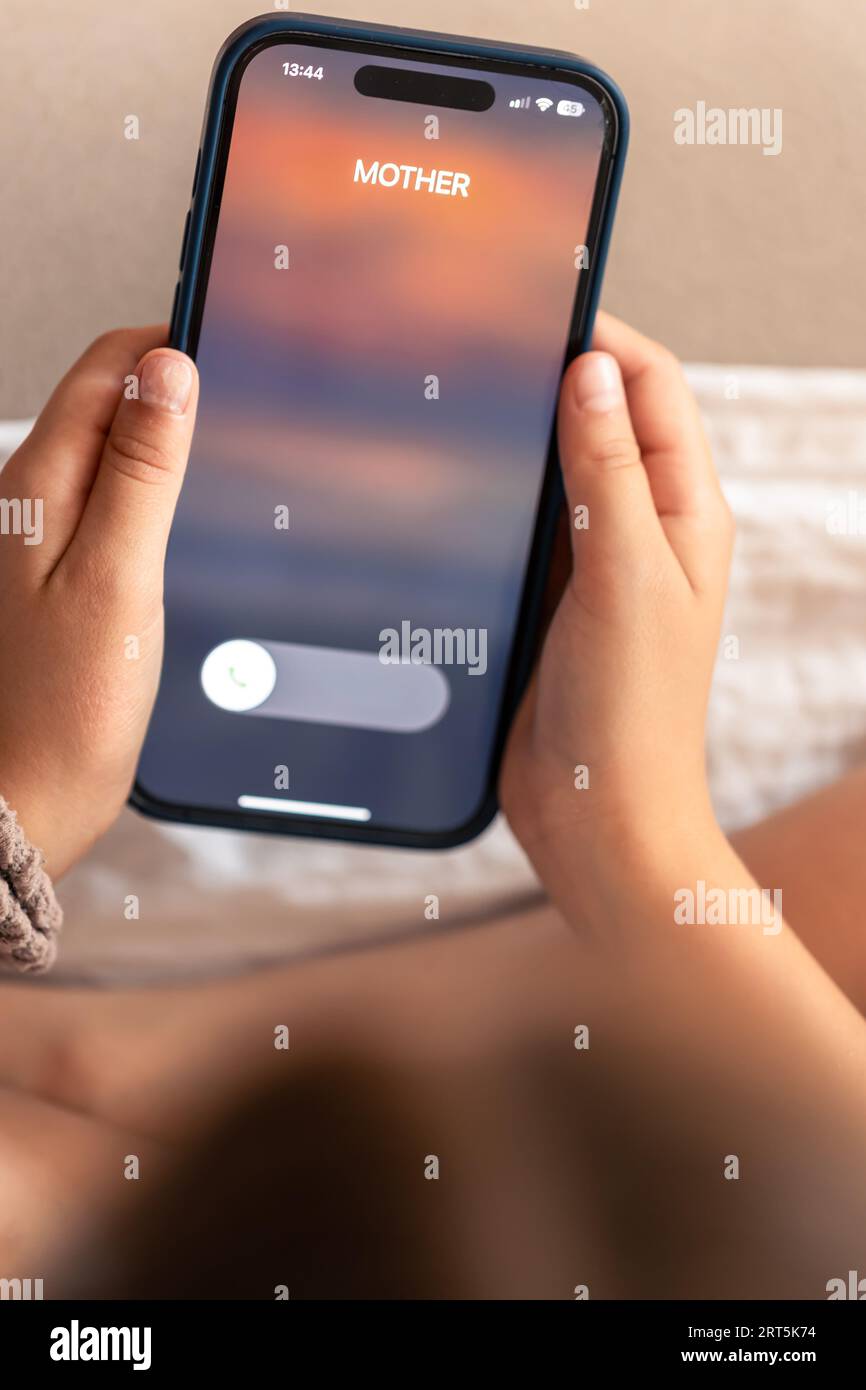 Smartphone in child hands with Incoming mother call on a screen Stock ...