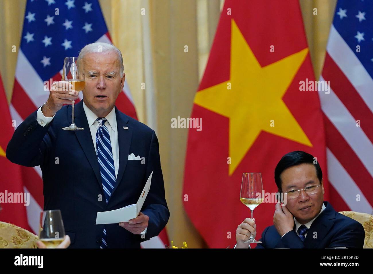 U.S. President Joe Biden raises a toast as he participates in a State ...