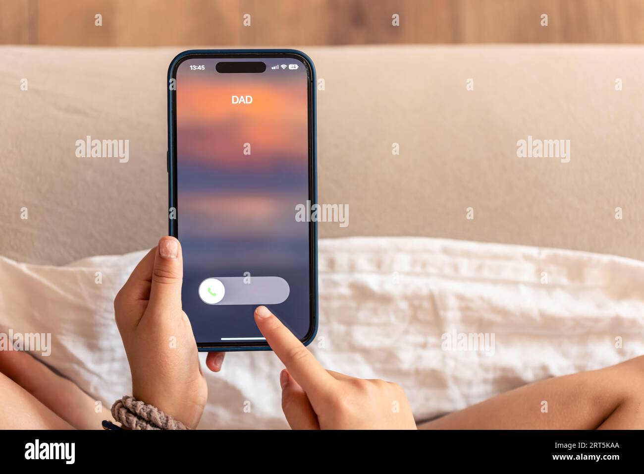 Close up of child hands holding phone with Dad's incoming call on ...