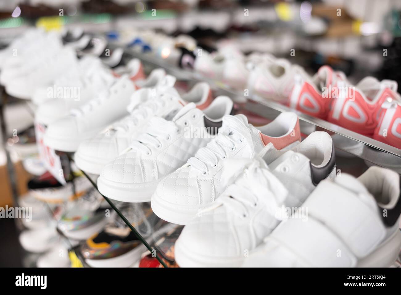 Showcase with models of sneakers in shoe store Stock Photo - Alamy