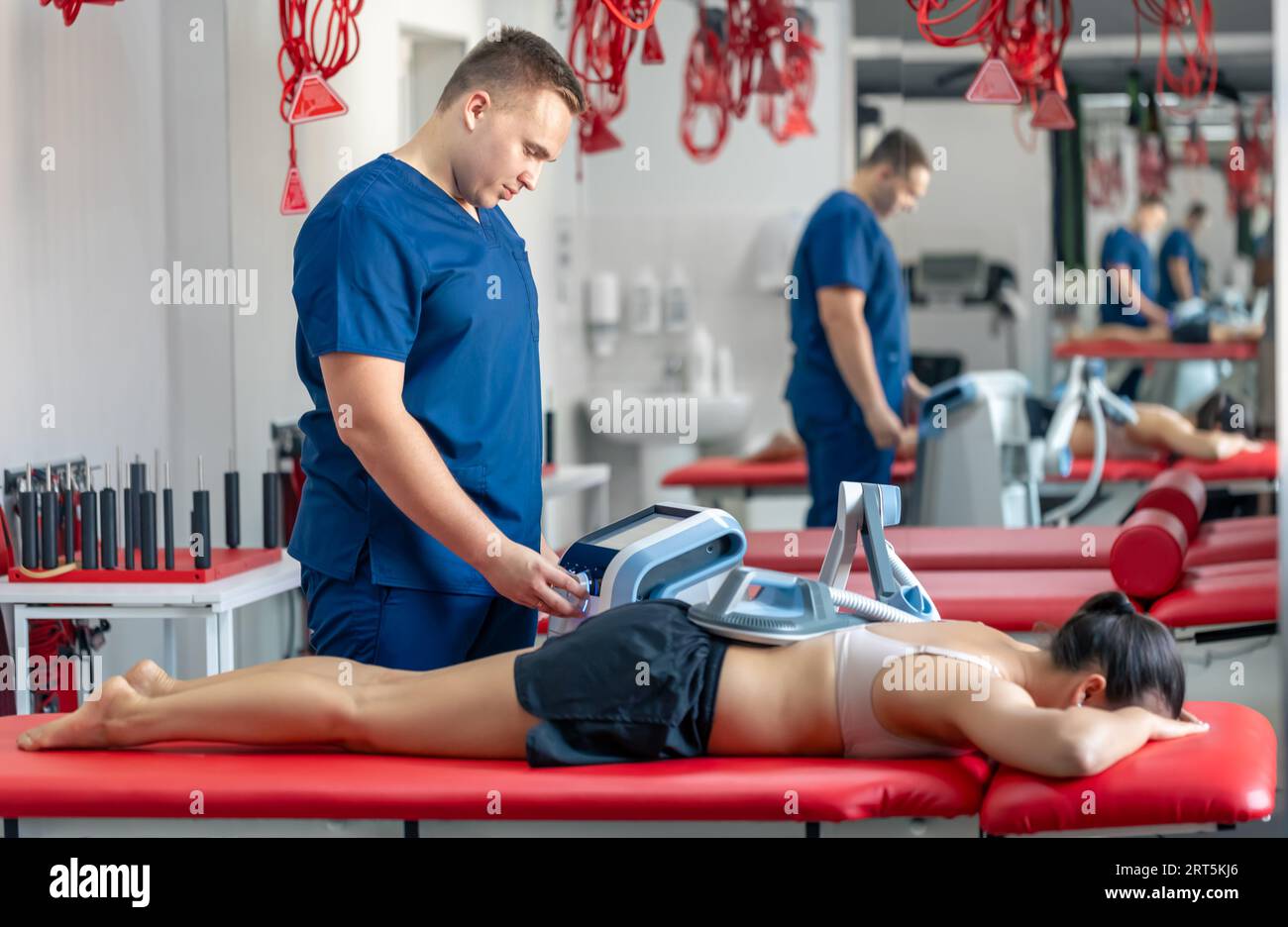 Electromagnetic therapy of the back, physiotherapist doctor uses ...