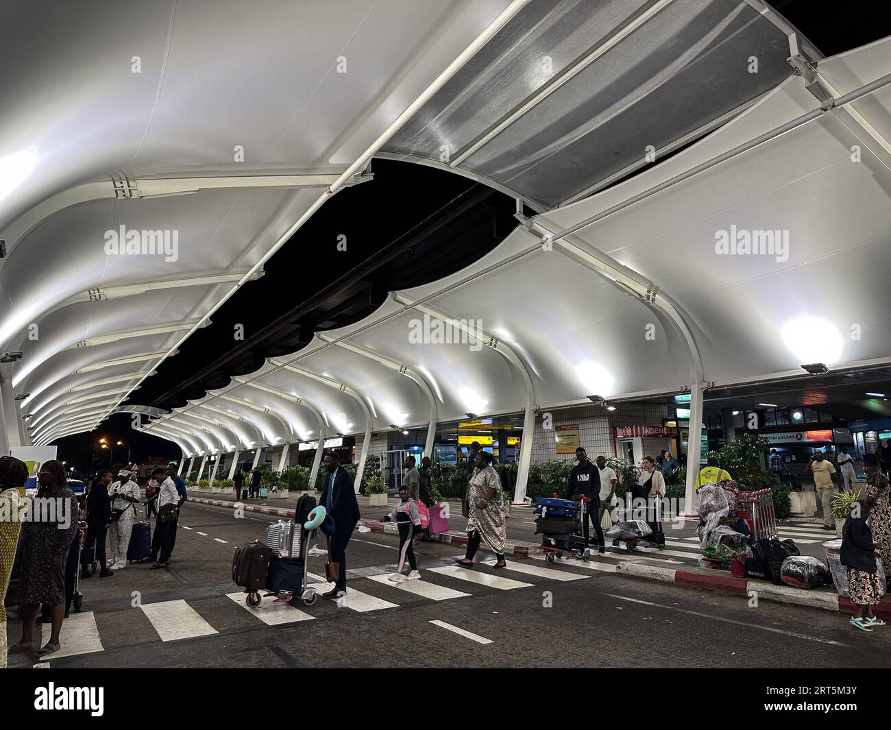 230906 -- LIBREVILLE, Sept. 6, 2023 -- Passengers walk out of the Leon ...