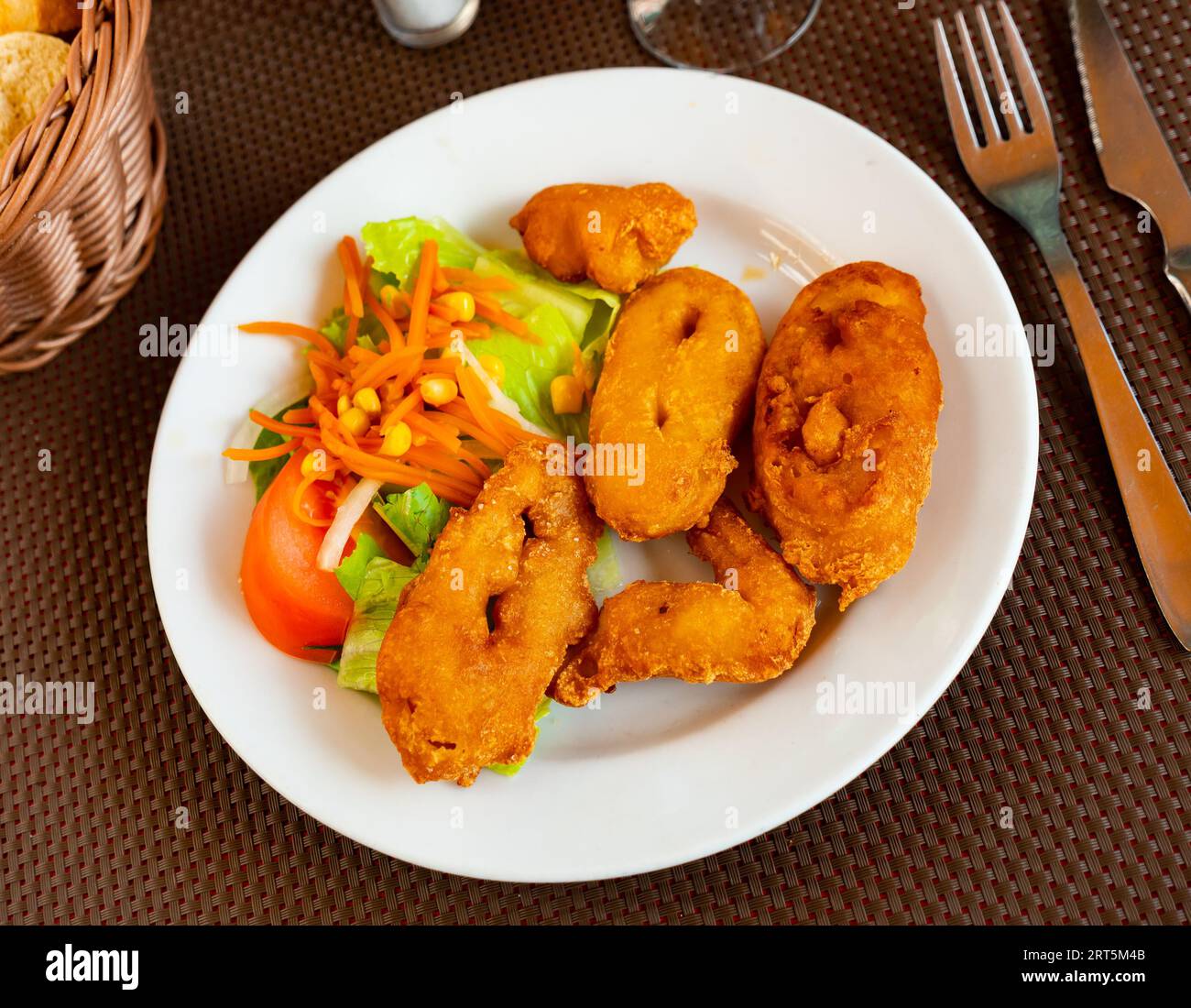 Fried andalusian squid served on plate in restaurant Stock Photo - Alamy