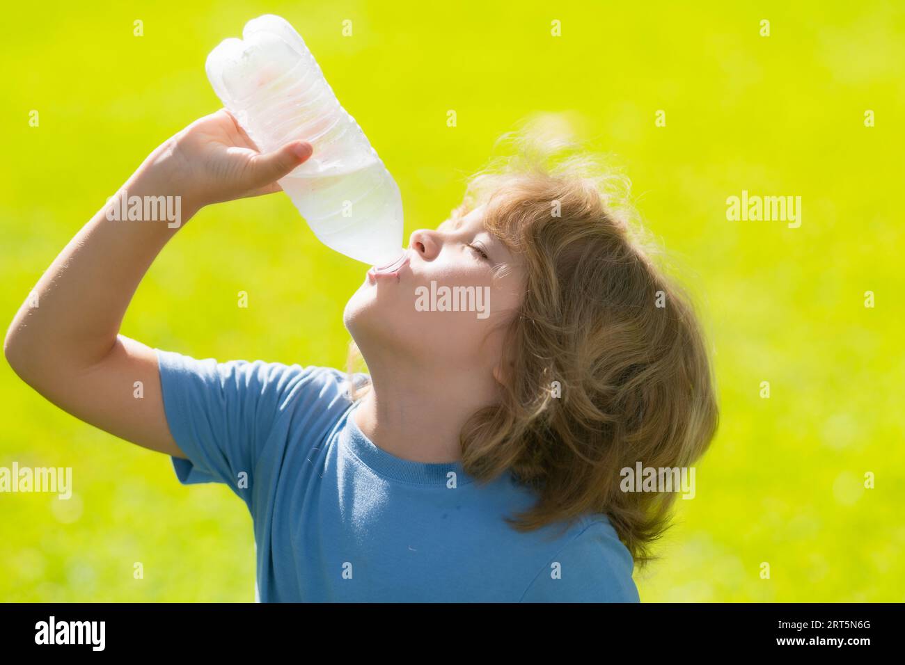 Child drinking water. Kid enjoy pure fresh mineral water. Outdoor kid ...