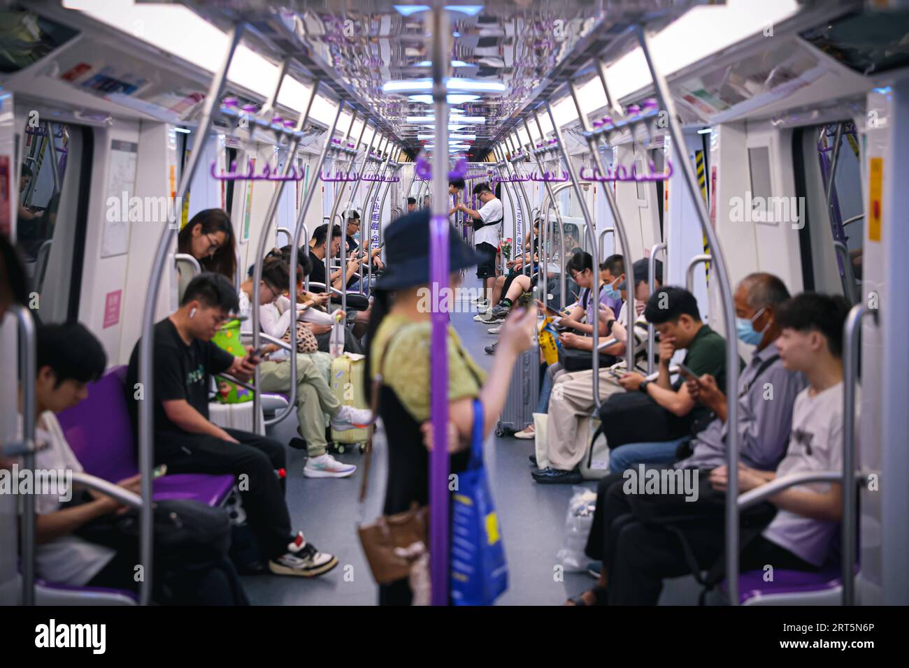 230908 -- HANGZHOU, Sept. 8, 2023 -- People ride a subway train adorned ...