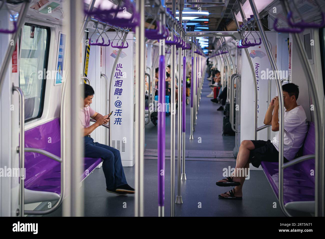 230908 -- HANGZHOU, Sept. 8, 2023 -- People ride a subway train adorned ...