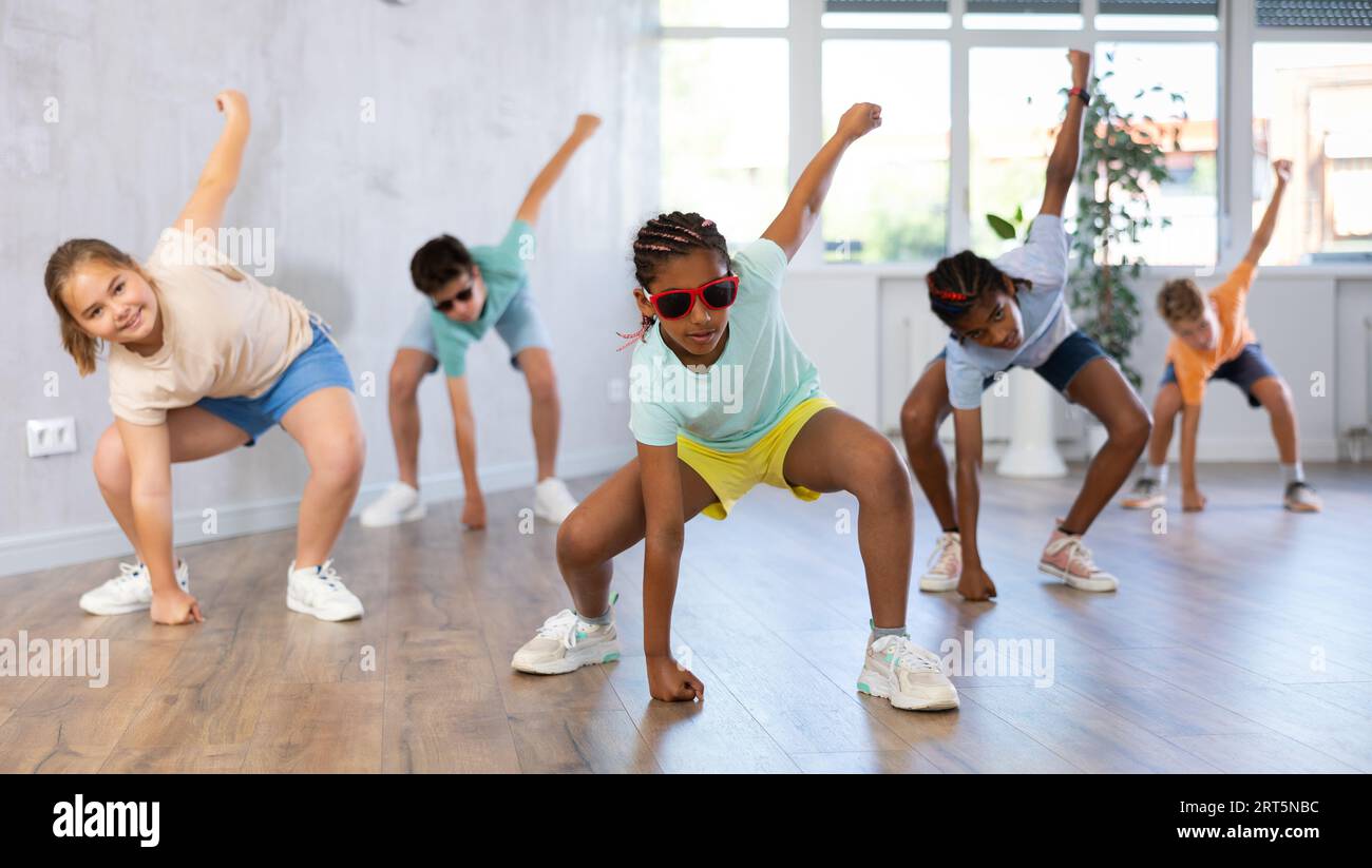 Cheerful african american preteen girl practicing hip-hop movements ... Cheerful african american preteen girl practicing hip-hop movements ...