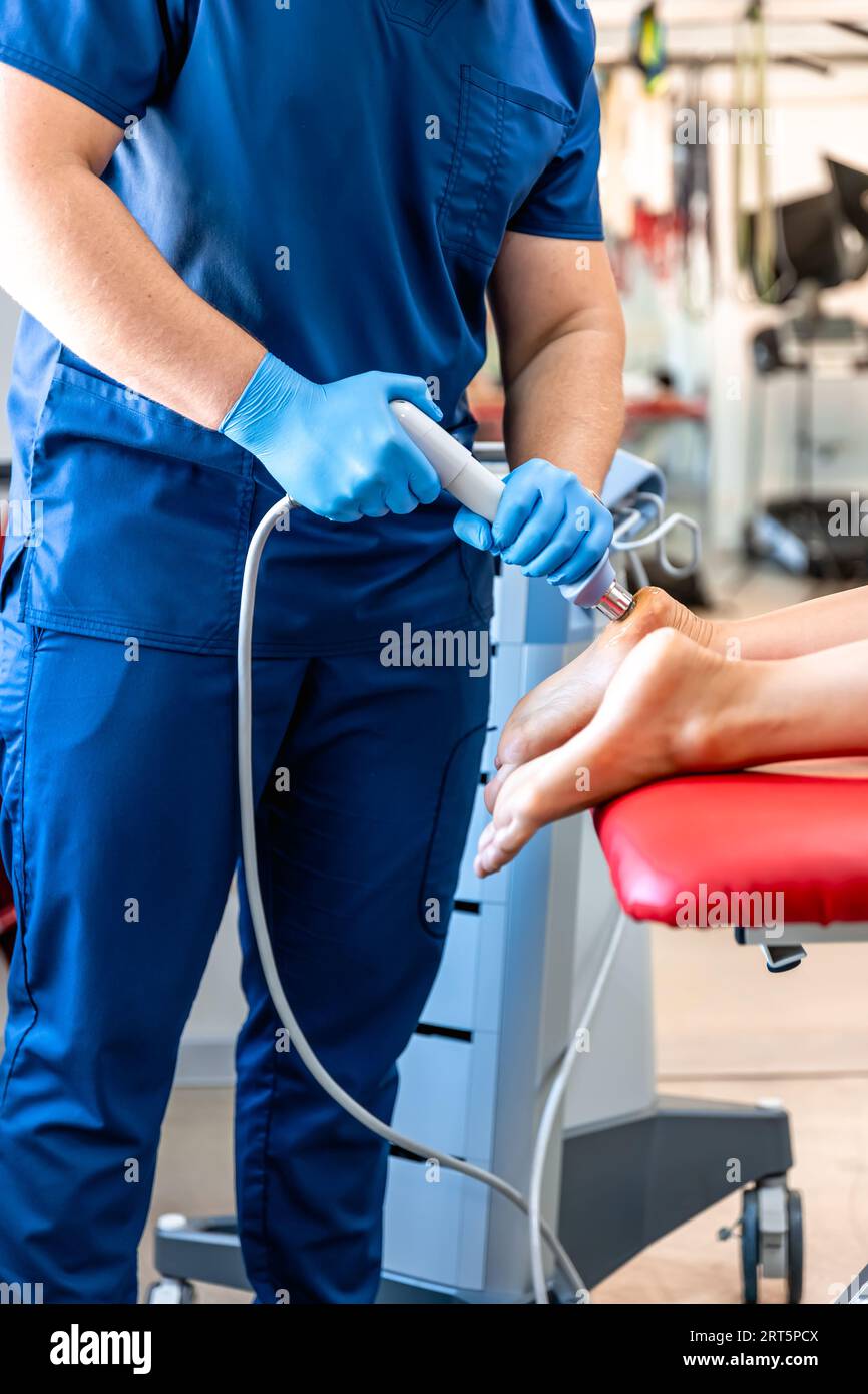 Patient getting non-surgical treatment with shock waves for plantar ...