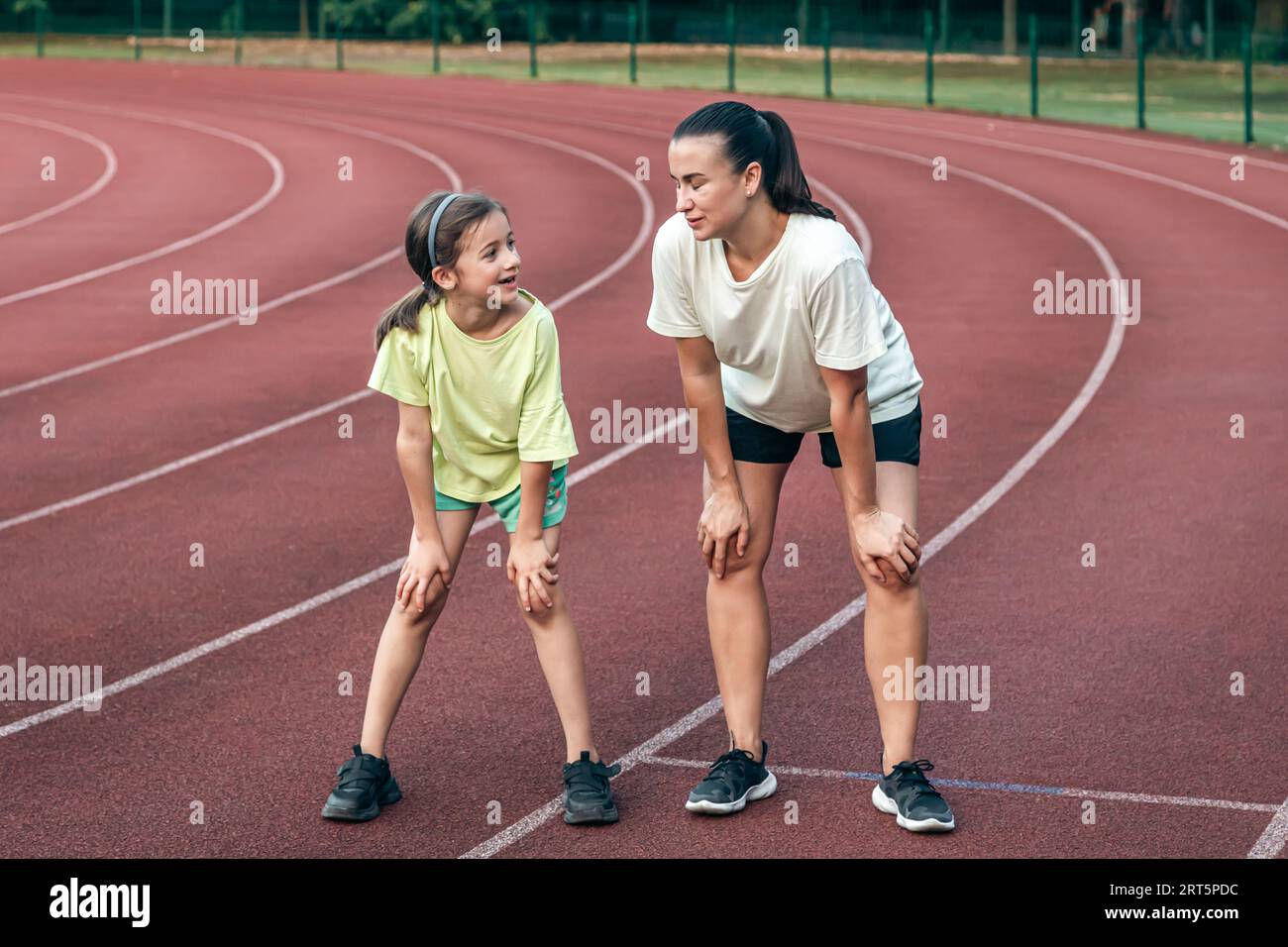 Mom and daughter jogging at the stadium Stock Photo - Alamy