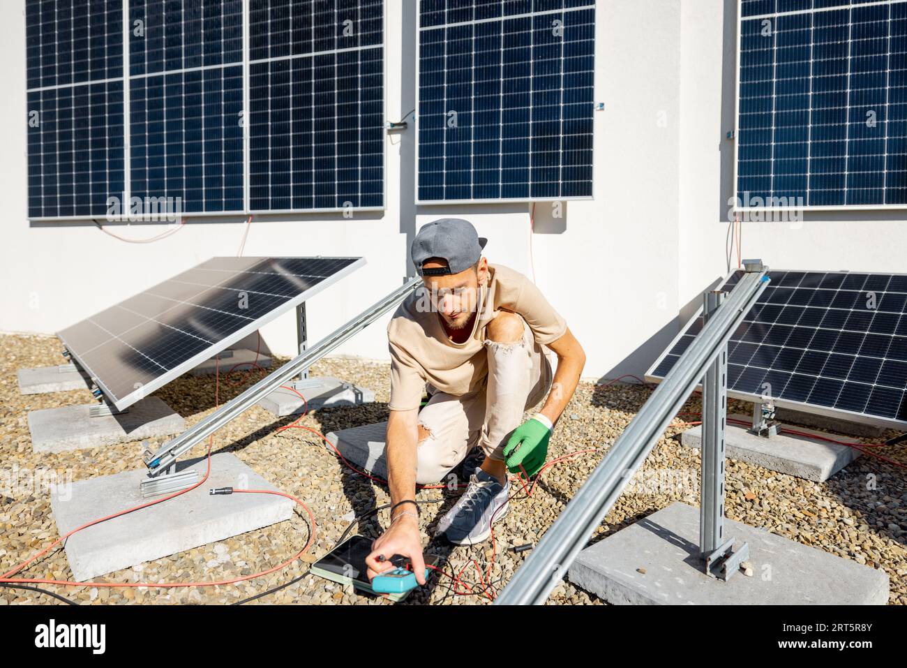 Electrician installing solar panels on a rooftop Stock Photo - Alamy
