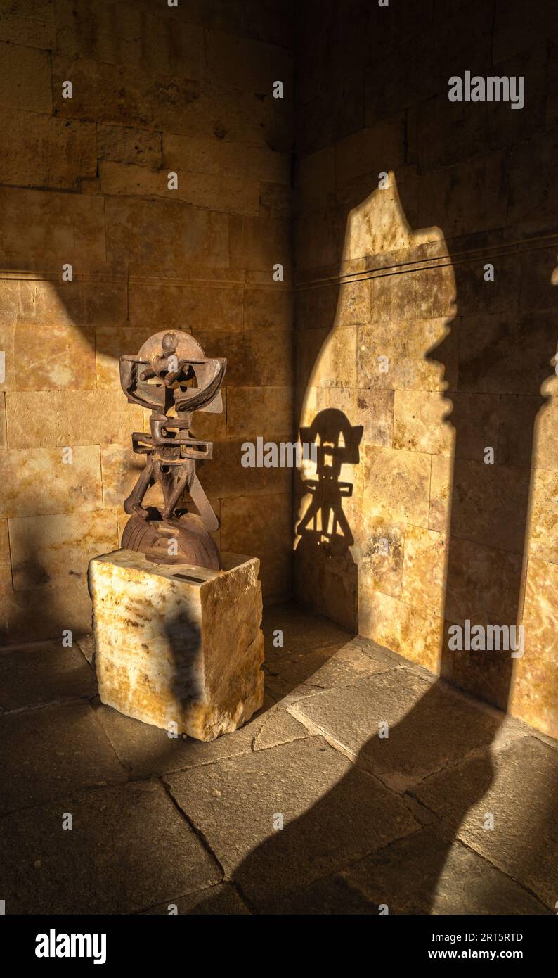 Abstract figurative wrought iron sculpture illuminated by the evening ...