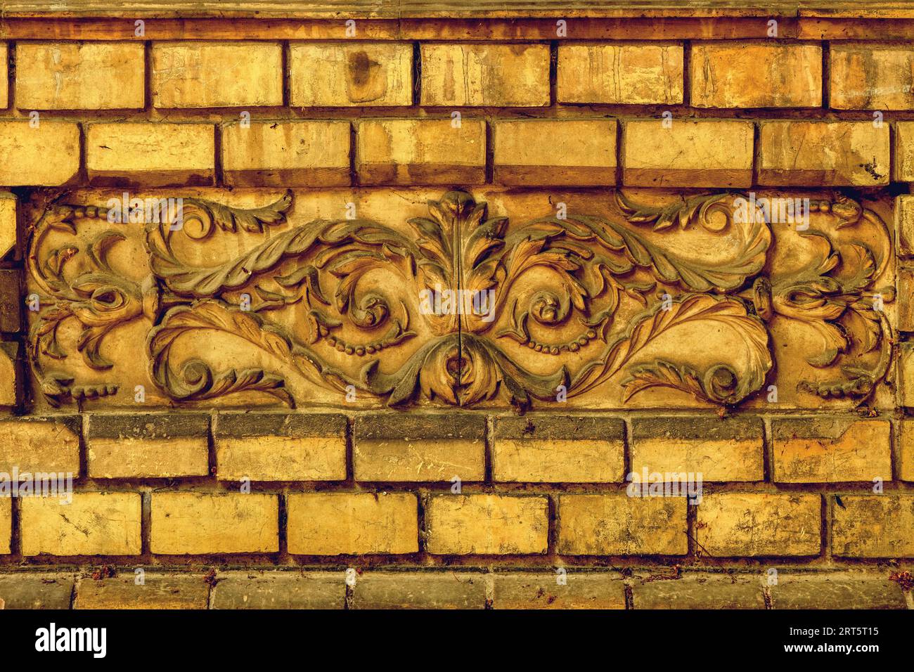 Vintage facade decoration made of concrete molding on rustic brick wall ...