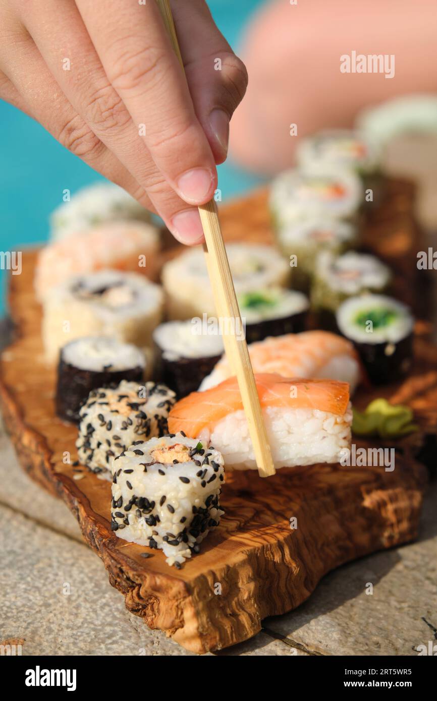 assorted sushi on a board near the pool Stock Photo - Alamy