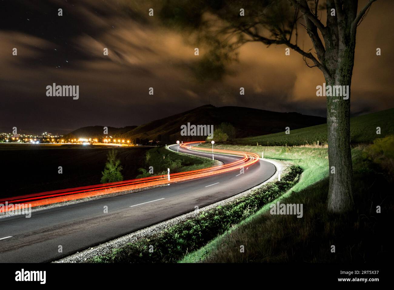 Traffic light line on the road at night Stock Photo - Alamy