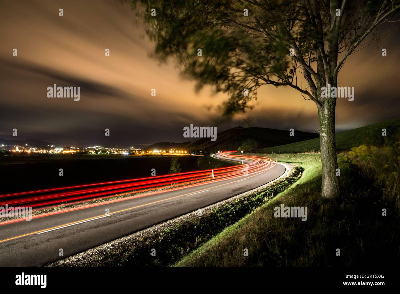 Traffic light line on the road at night Stock Photo - Alamy