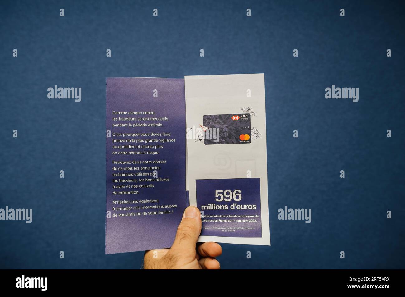 Paris, France - Jul 12, 2023: A person holding an open brochure ...