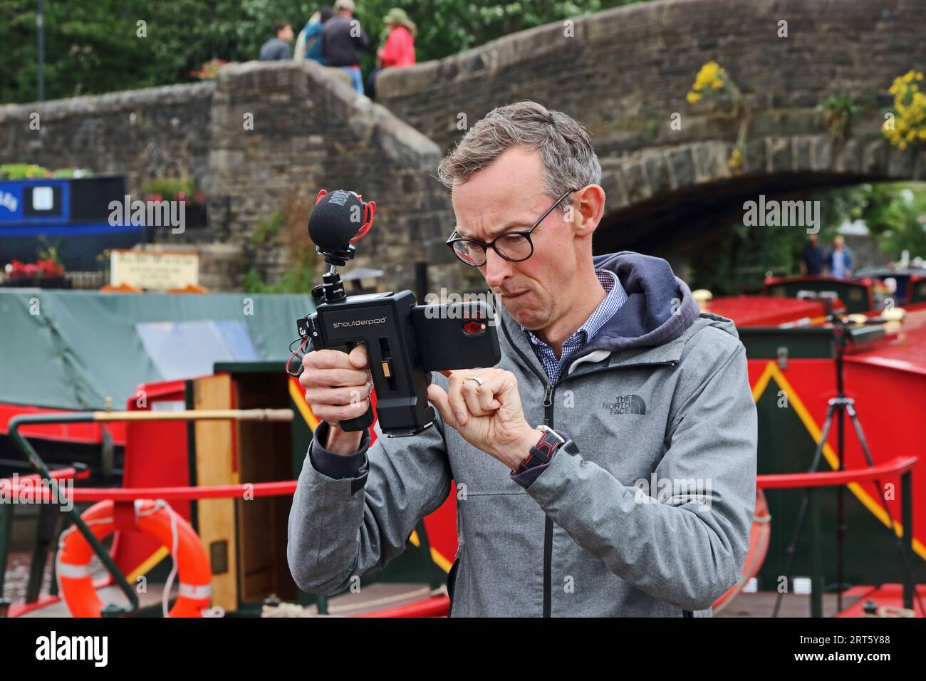 BBC Look North reporter Spencer Srokes checks video after interview ...