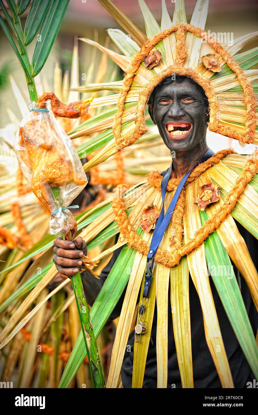Toothless man holding a chicken at Ati Atihan festival Stock Photo - Alamy