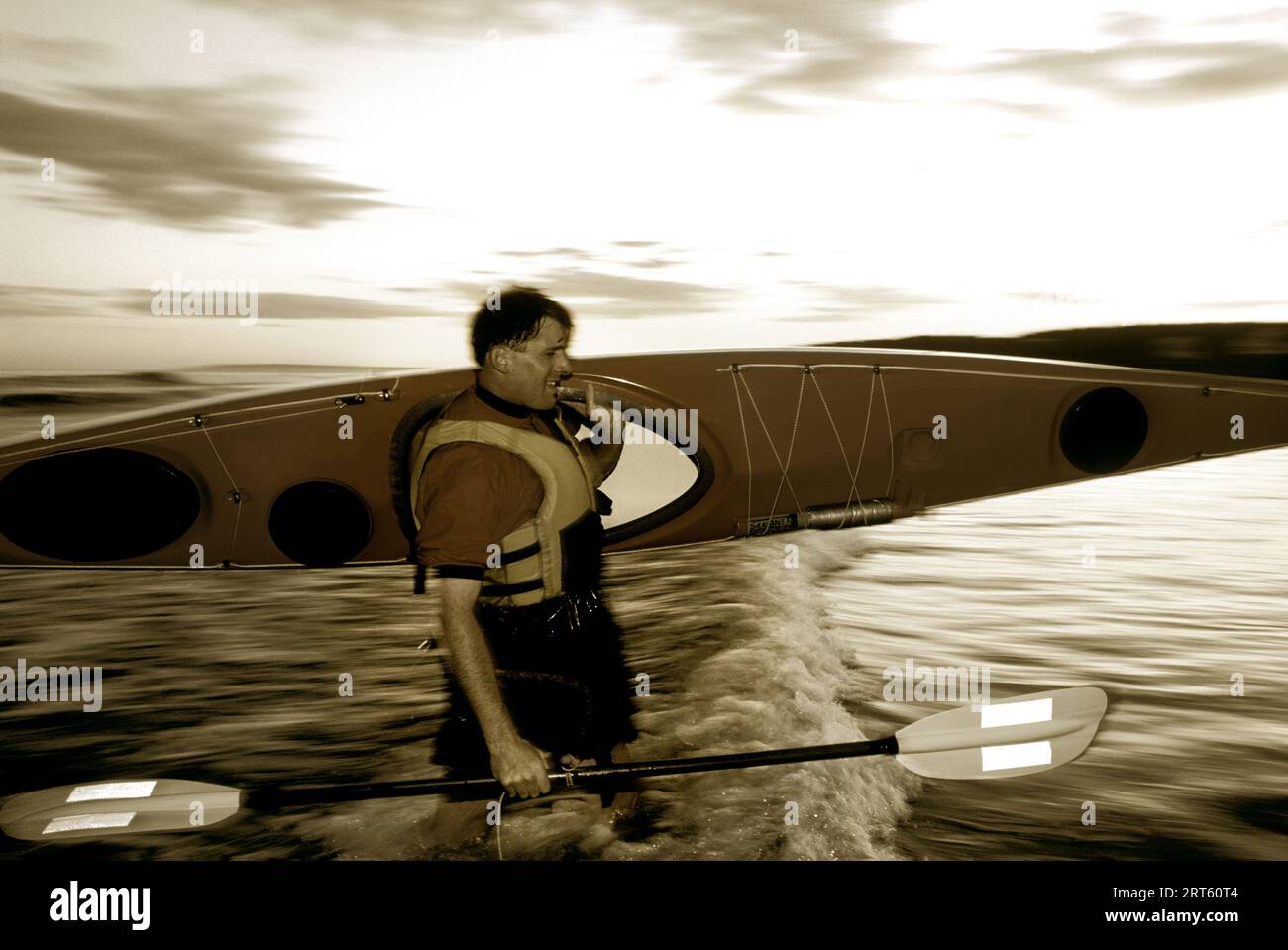 Man carrying his sea kayak, Higgins Beach, Maine Stock Photo - Alamy