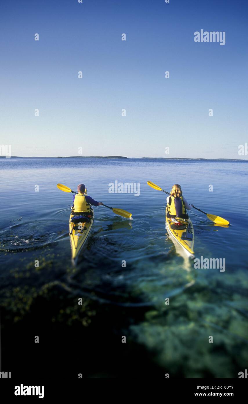 Two women set out on a kayak adventure, Muscongus Bay, Maine Stock ...