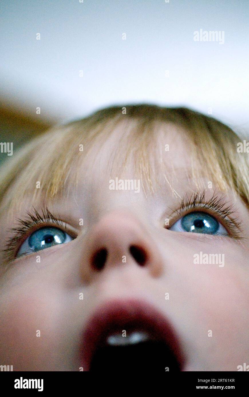 Young girl looking up and staring. (intentional grain Stock Photo - Alamy