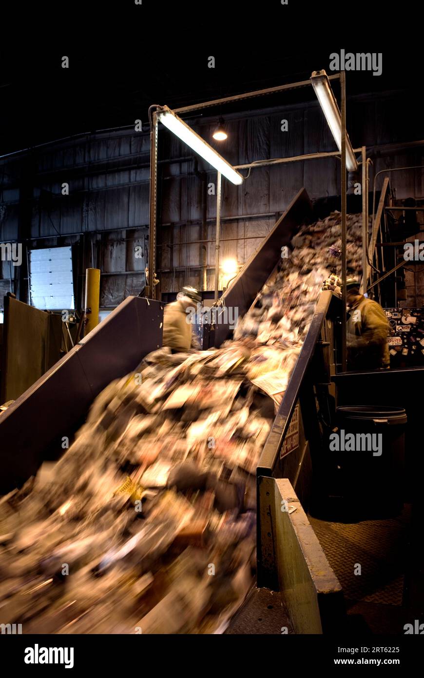 Sorting newspaper on a conveyor belt in a recycling plant Stock Photo ...