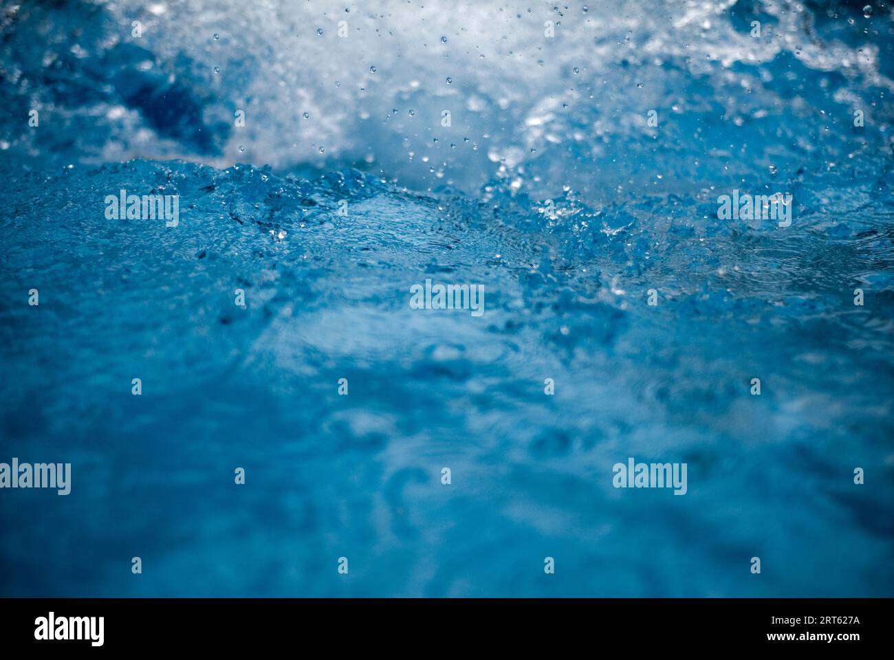 Splash in blue water Stock Photo - Alamy
