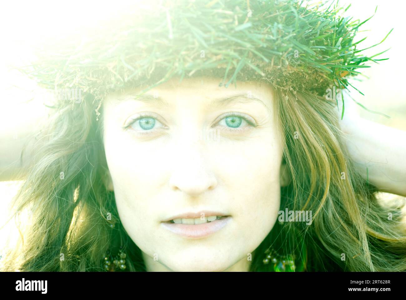 Portrait of a nature loving woman wearing a grass hat Stock Photo - Alamy