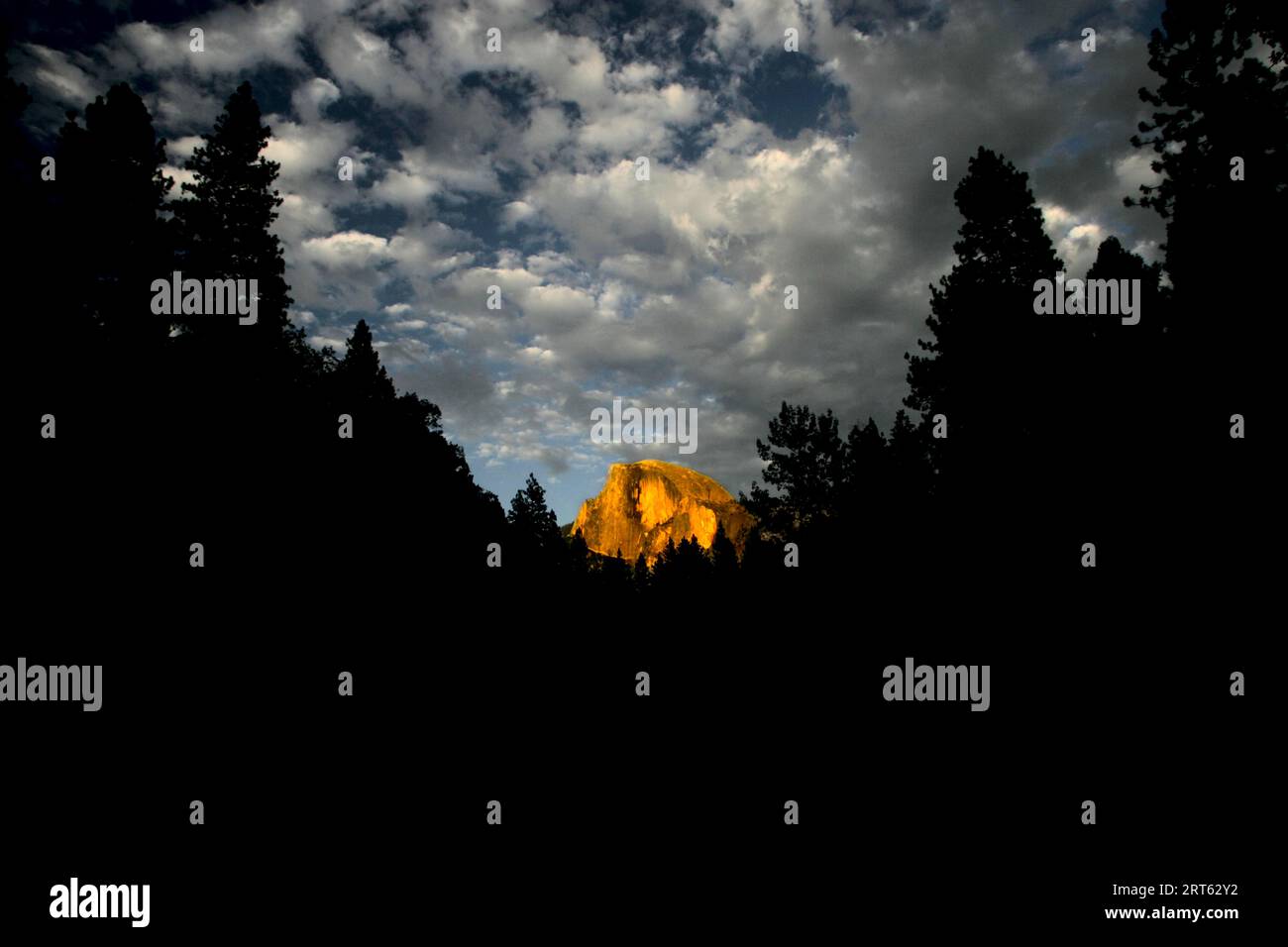 The last of the setting sun illuminates Half Dome monolith in Yosemite ...