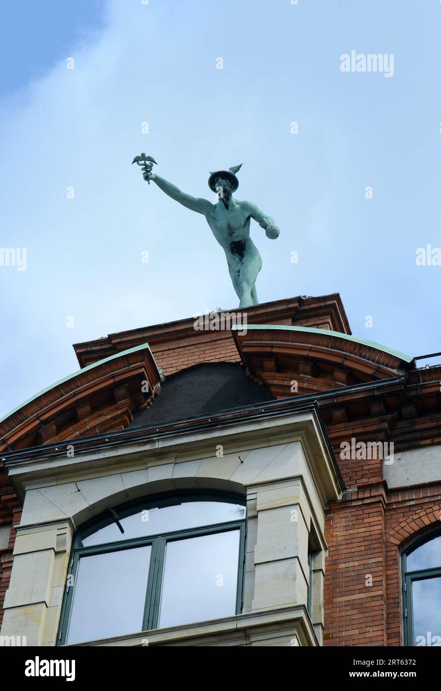 A Bronze sculpture of Mercury on the roof of a building. Købmagergade ...