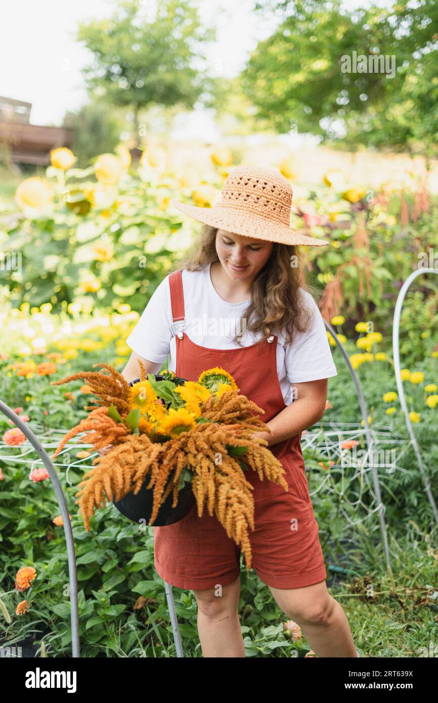 A flower farmer carrying a fall flower bouquet from her cut flow Stock ...