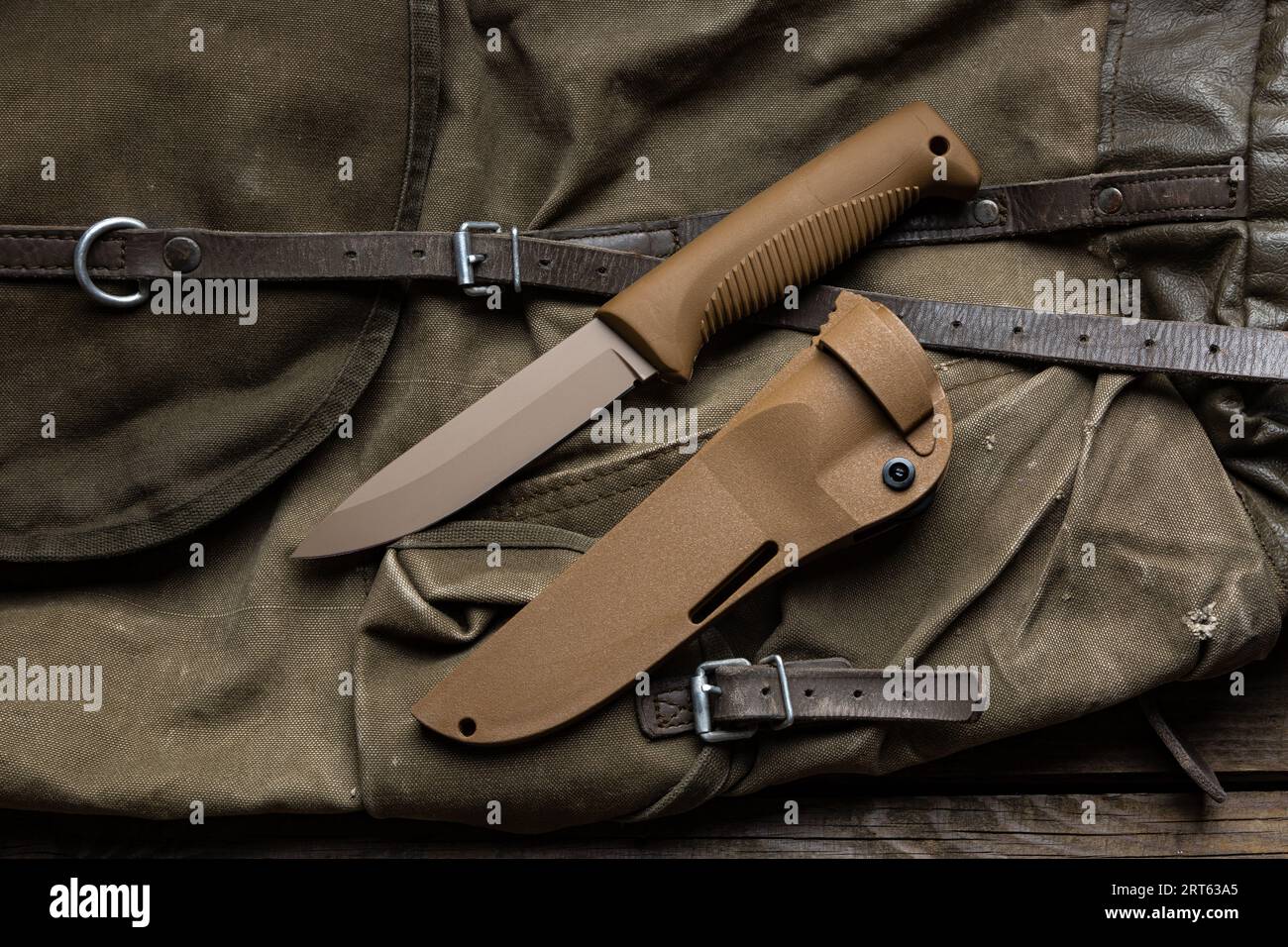 Modern knife with rubberized handle and plastic sheath. Cold steel lies ...