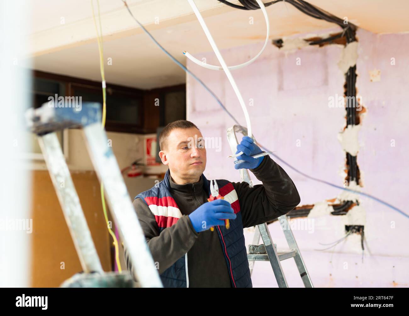 Repair man working on electric wires Stock Photo - Alamy