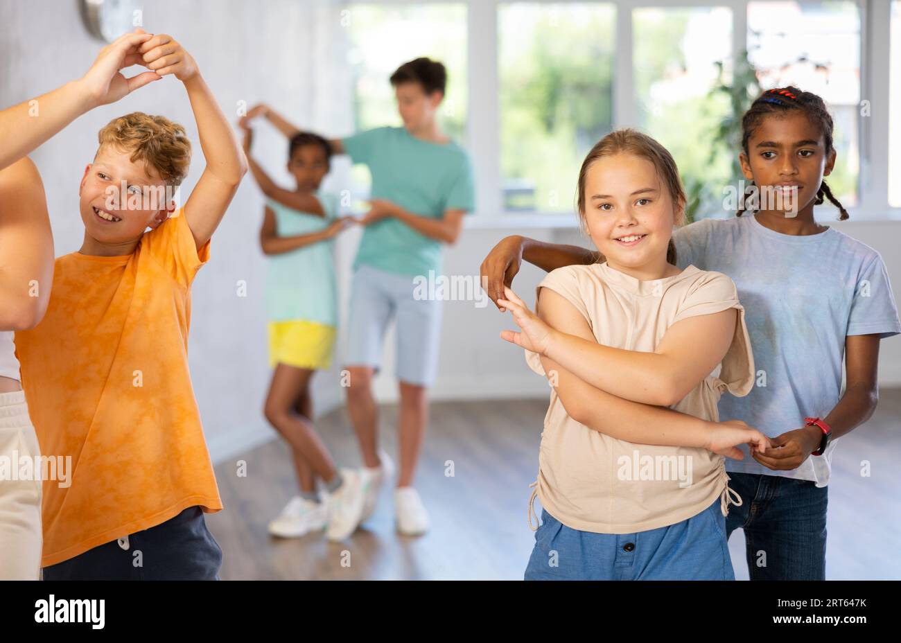 African boy and European girlie learn figures of pair jive dance and ...