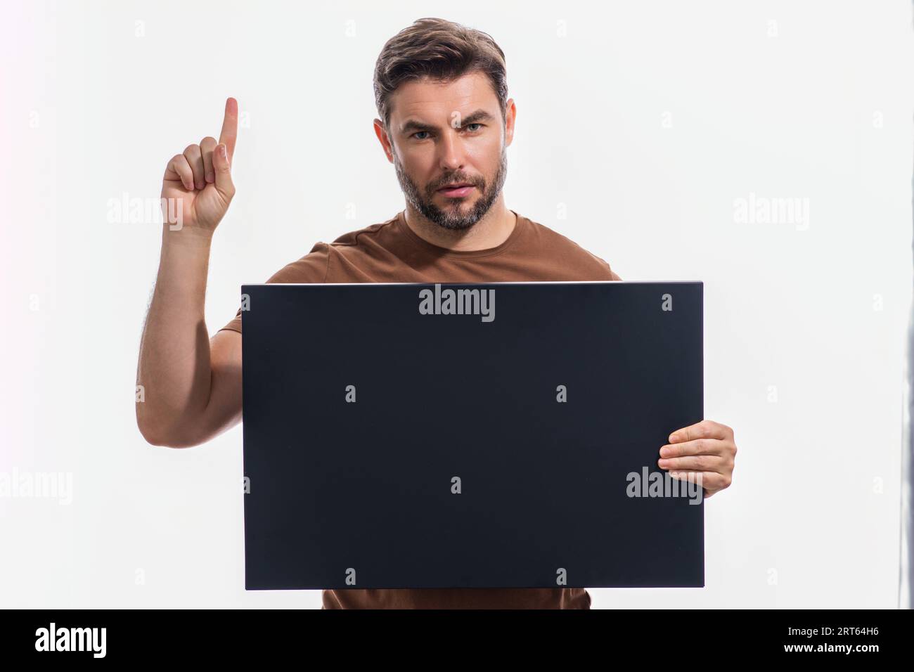 Happy man hold board thinking of idea on studio background. Portrait of ...