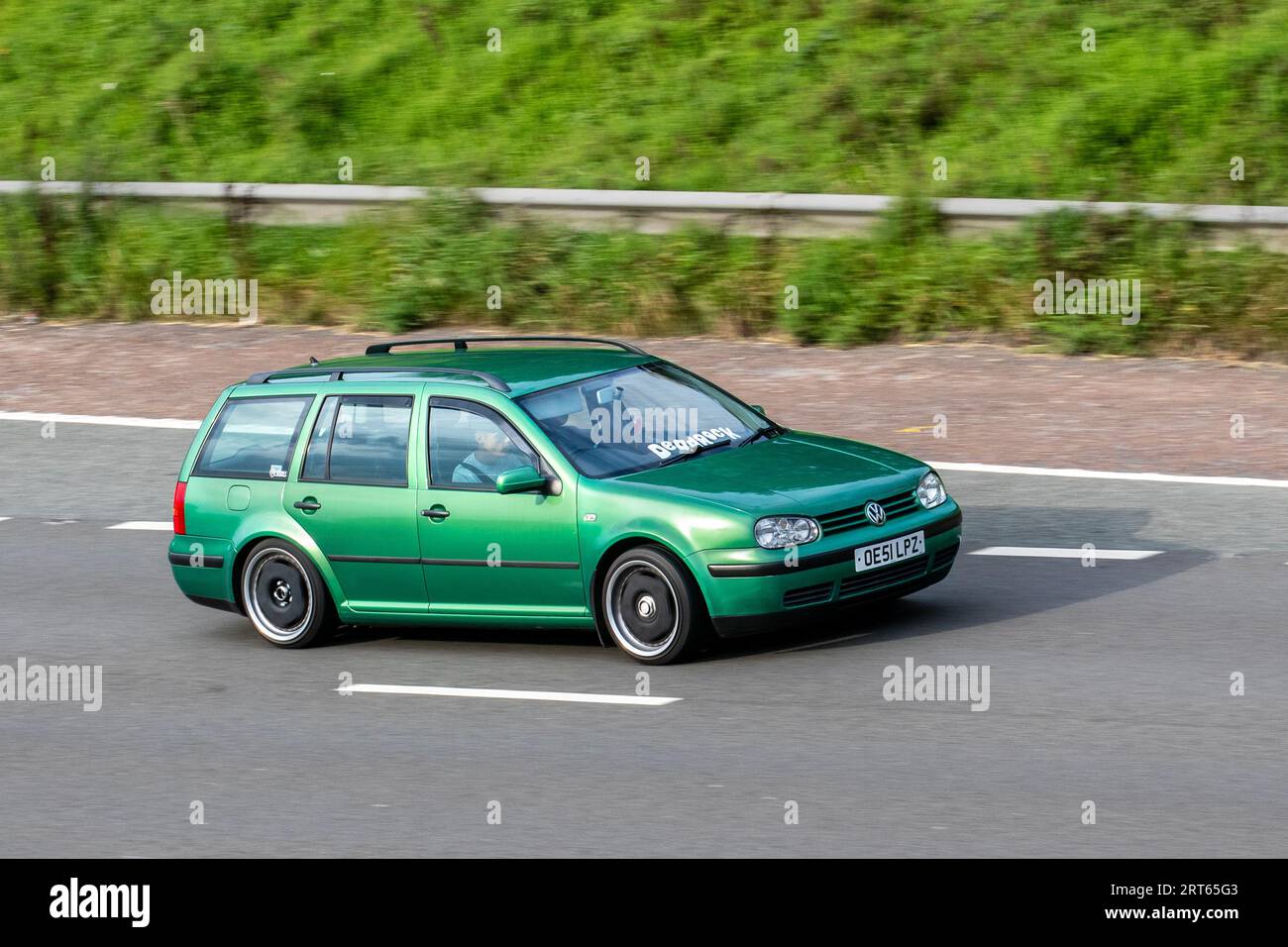 2001 Green VW Volkswagen Golf Estate with repainted doors travelling at ...
