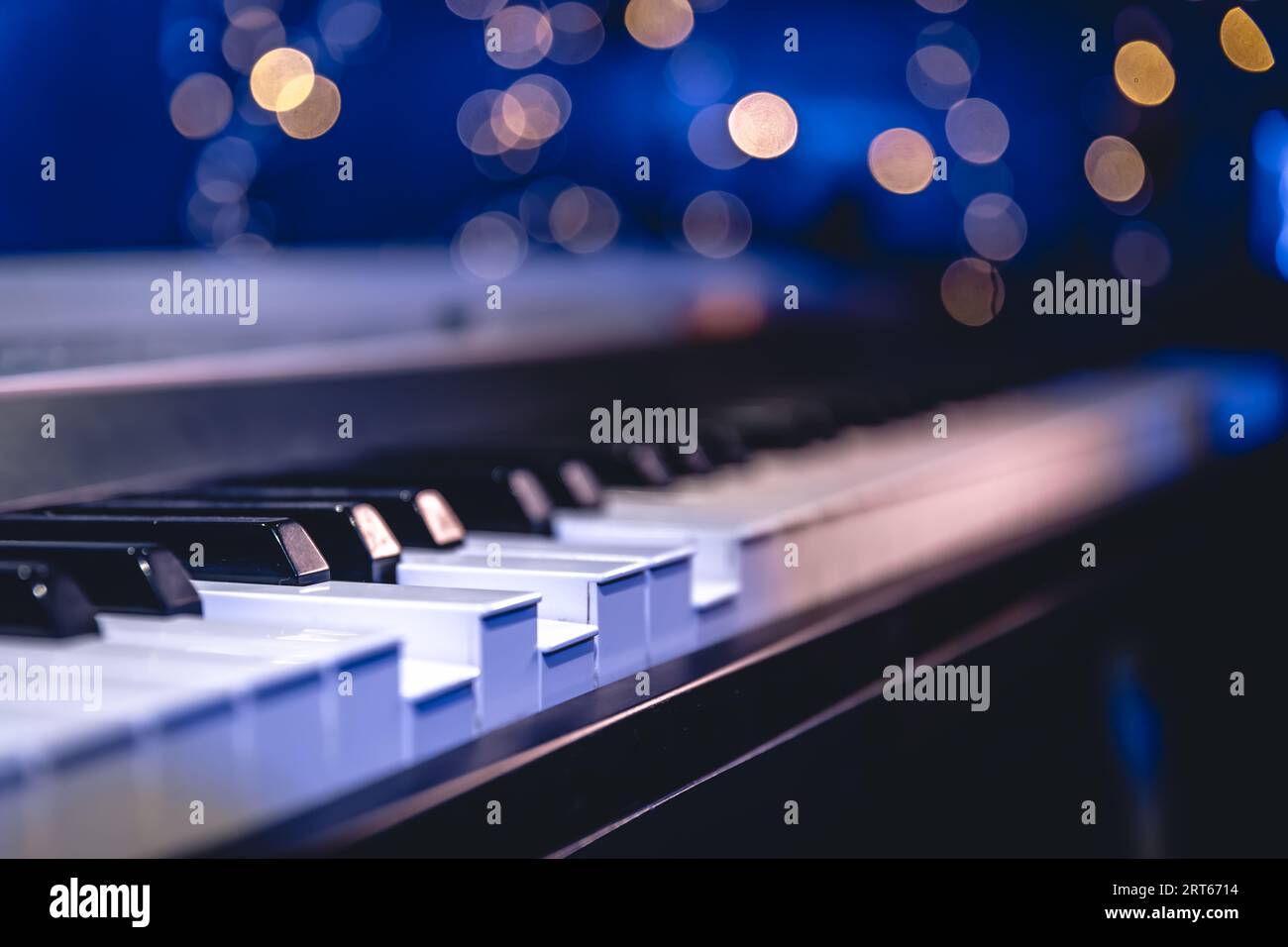 Piano keys close-up on a blurred background with bokeh Stock Photo - Alamy