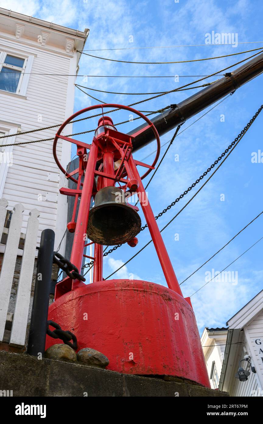 An old buoy with brass bell on display in the well kept and charming ...